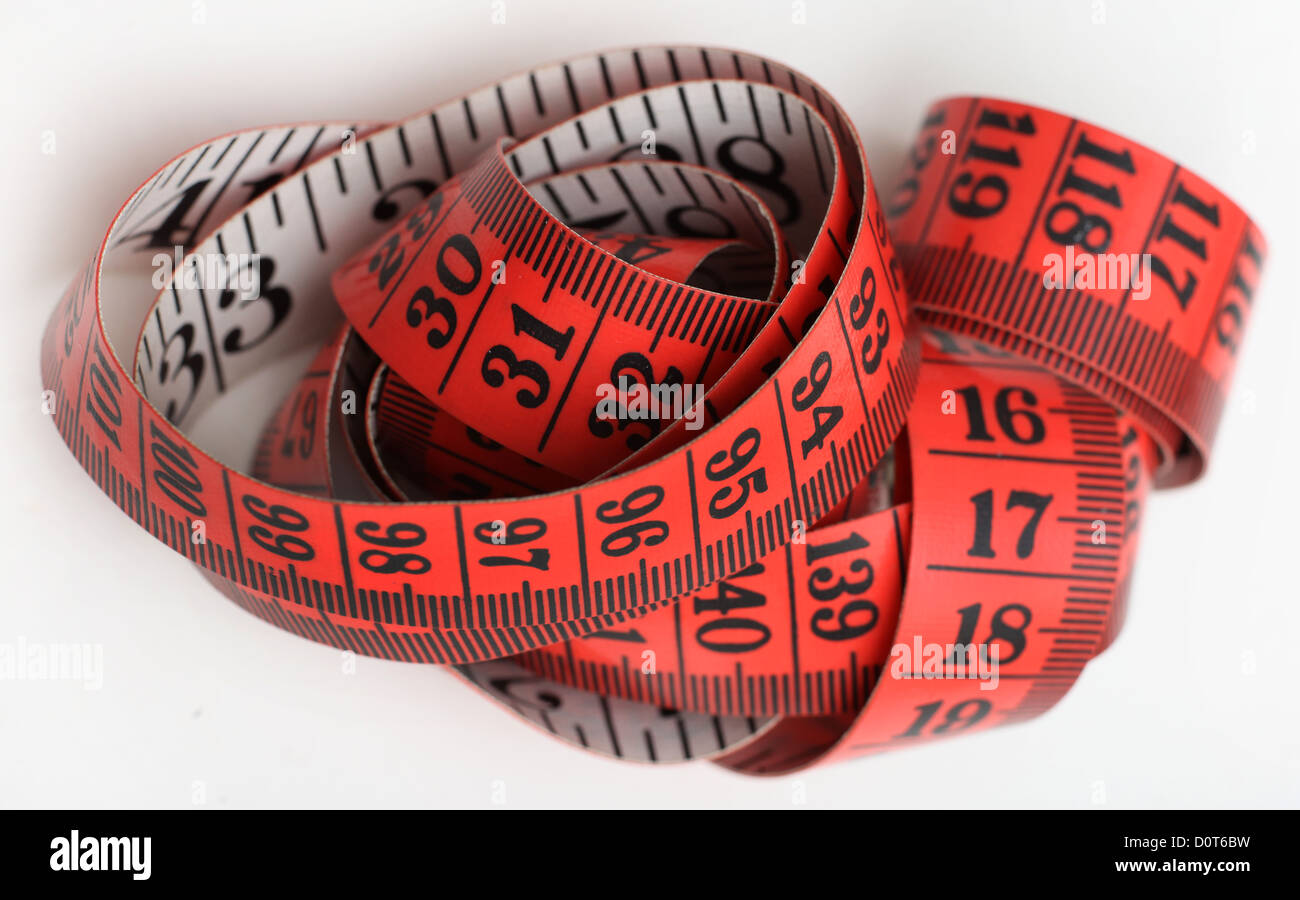 A ROLLED UP RED TAPE MEASURE. PHOTOGRAPHED BY JAMIE MANN Stock Photo ...