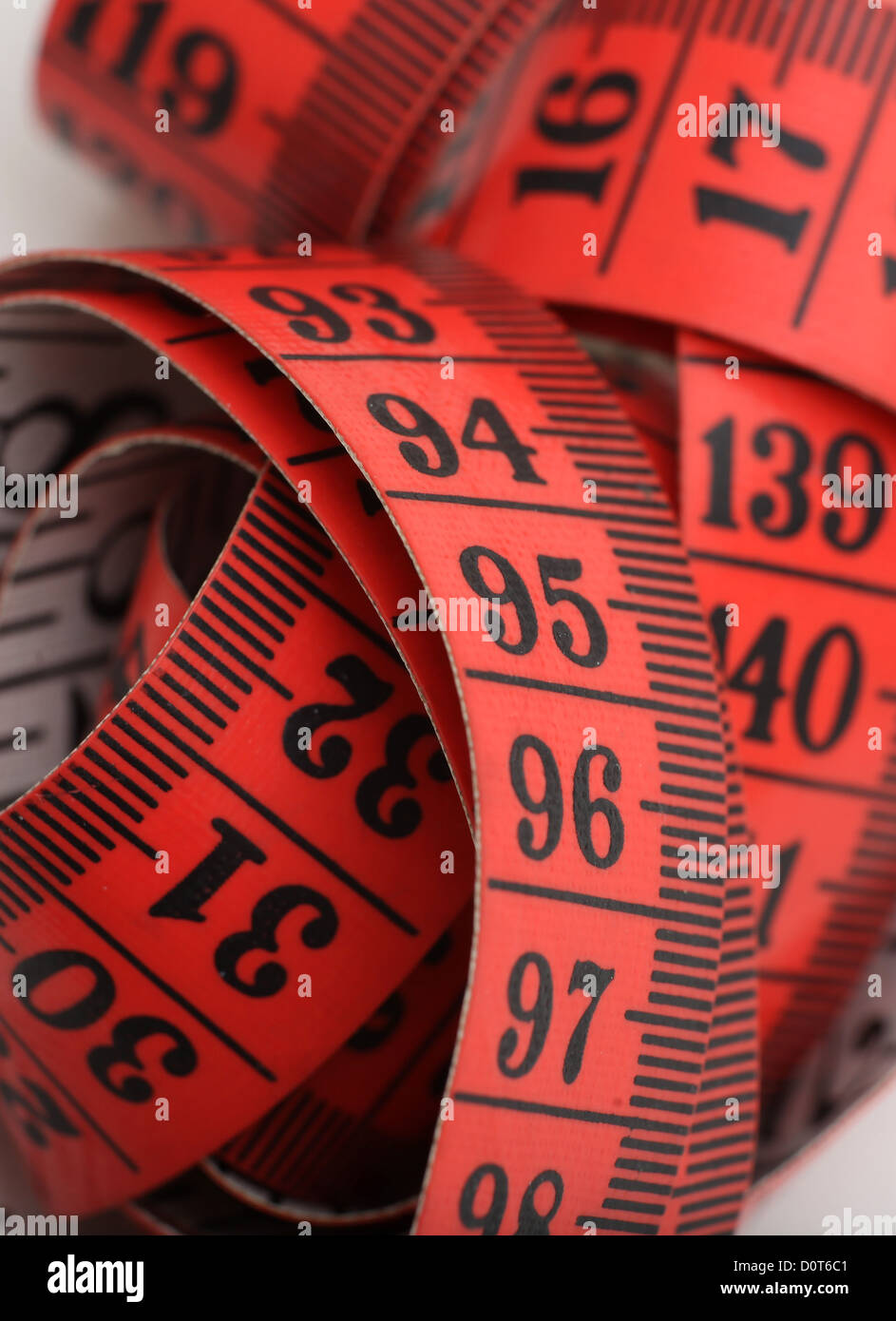 A ROLLED UP RED TAPE MEASURE. PHOTOGRAPHED BY JAMIE MANN Stock Photo ...