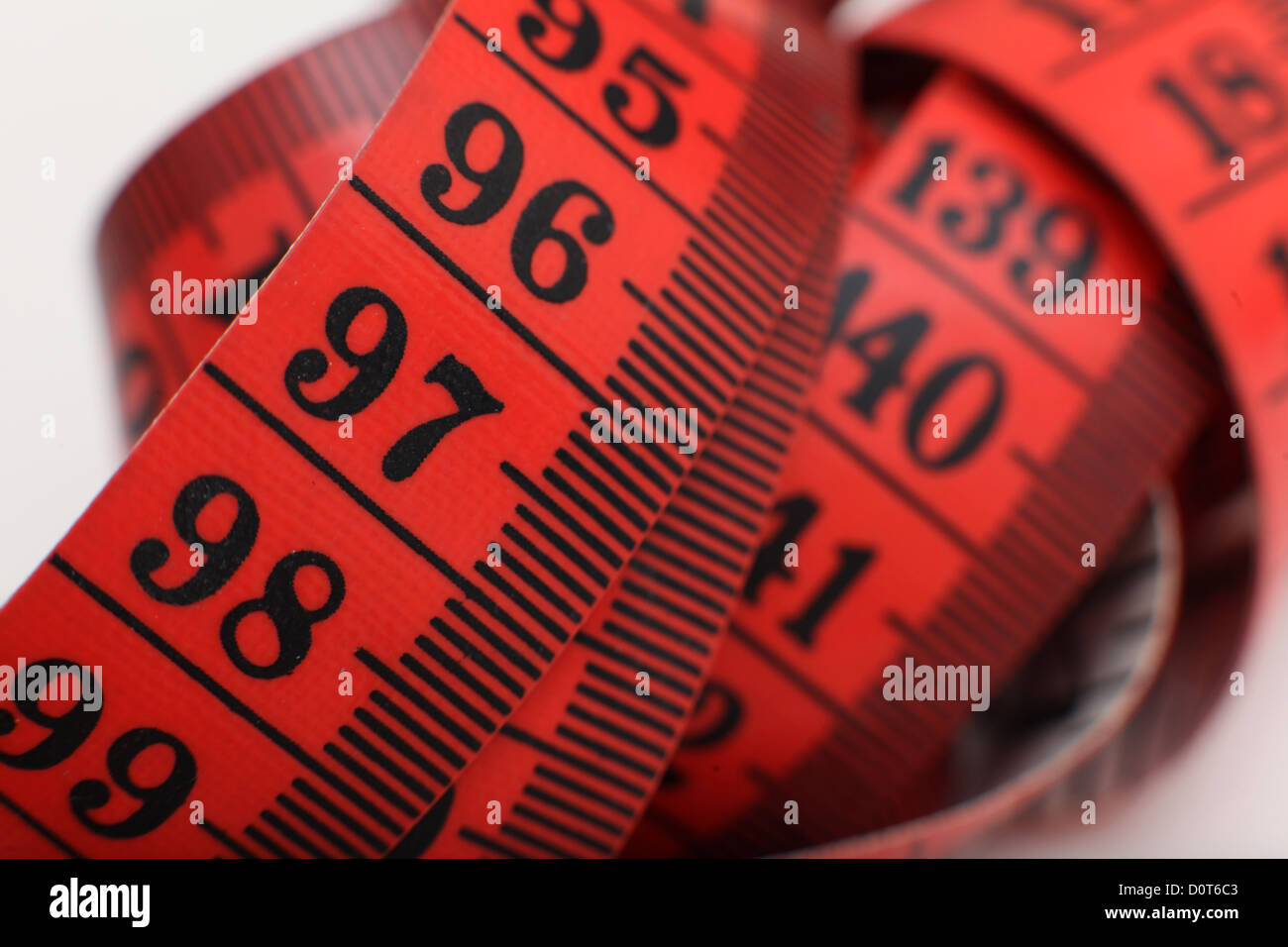 A ROLLED UP RED TAPE MEASURE. PHOTOGRAPHED BY JAMIE MANN Stock Photo ...