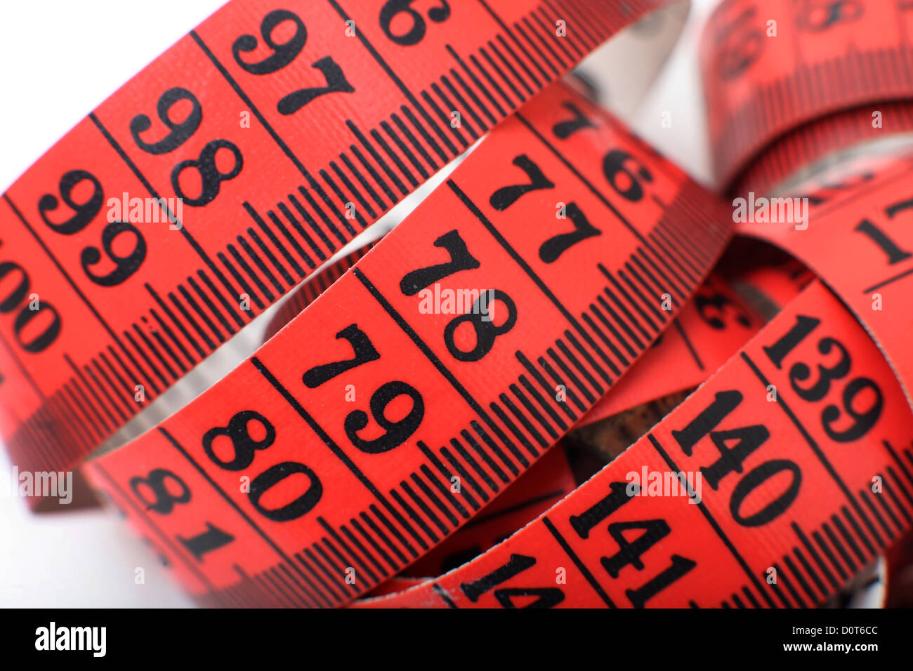 A ROLLED UP RED TAPE MEASURE. PHOTOGRAPHED BY JAMIE MANN Stock Photo ...