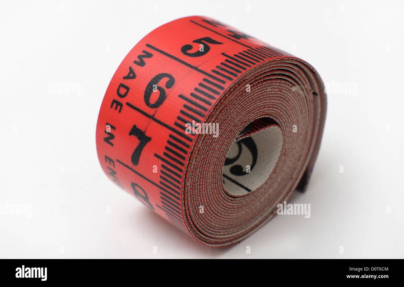 A ROLLED UP RED TAPE MEASURE. PHOTOGRAPHED BY JAMIE MANN Stock Photo ...