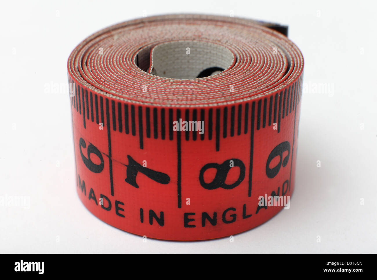 A ROLLED UP RED TAPE MEASURE. PHOTOGRAPHED BY JAMIE MANN Stock Photo ...