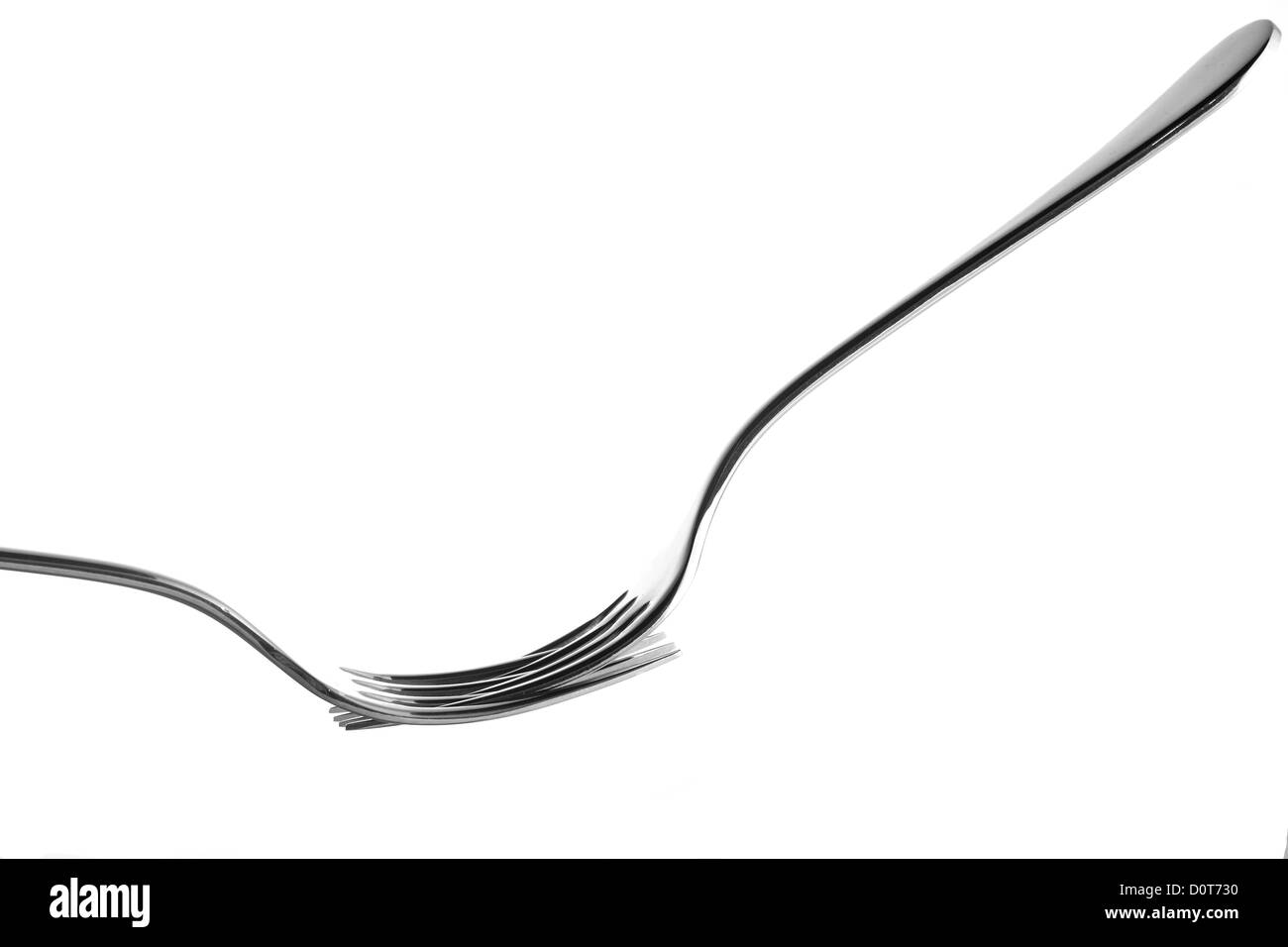 Two silver forks on white balancing Stock Photo - Alamy