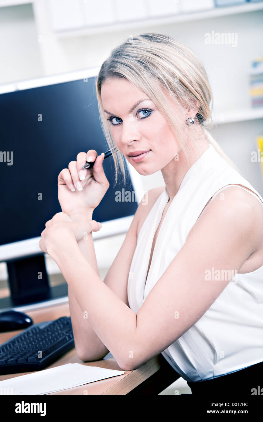 A young woman working in the office Stock Photo - Alamy