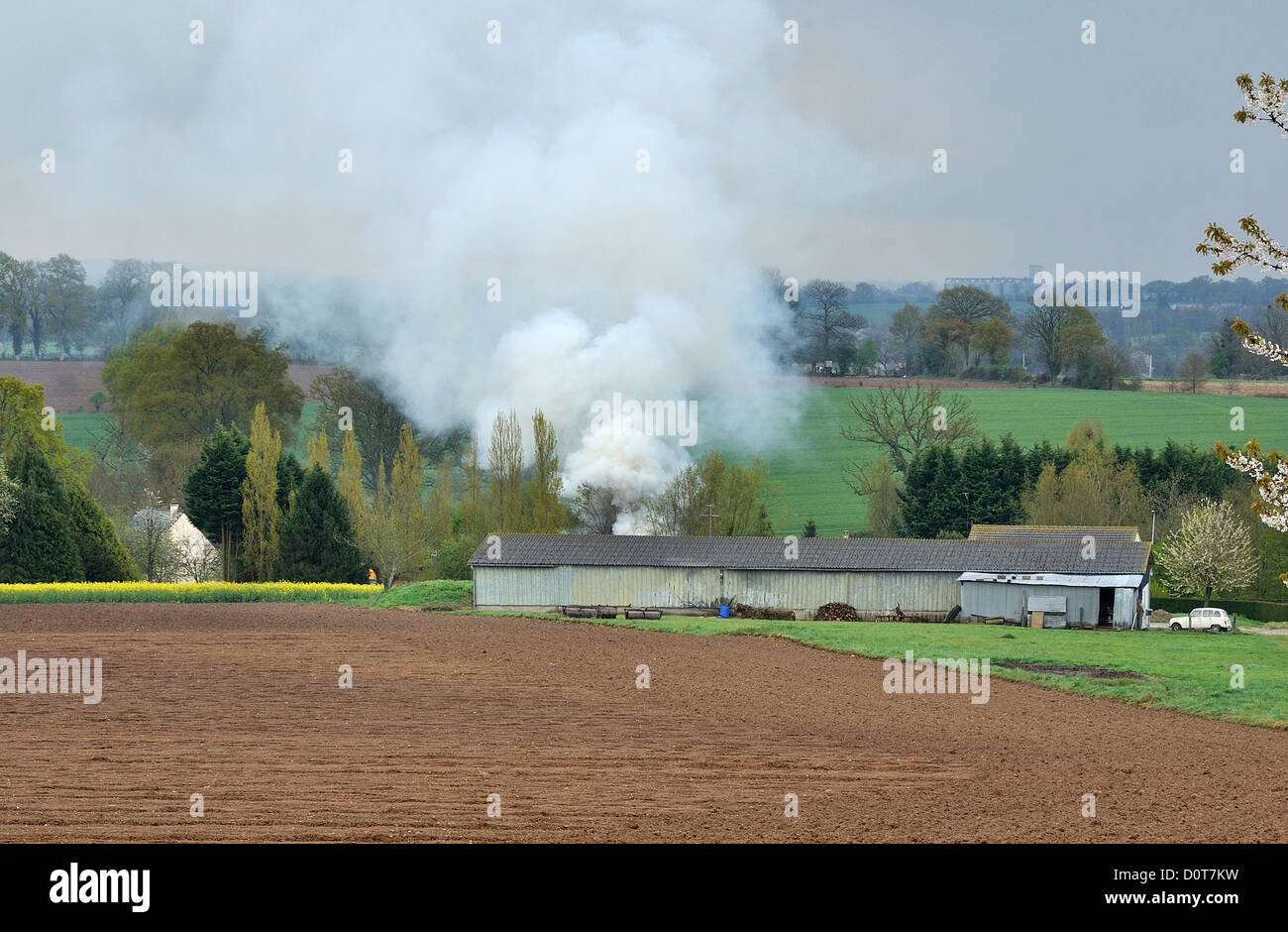 Burning of branches in the countryside (Mayenne, France), near a farm ...
