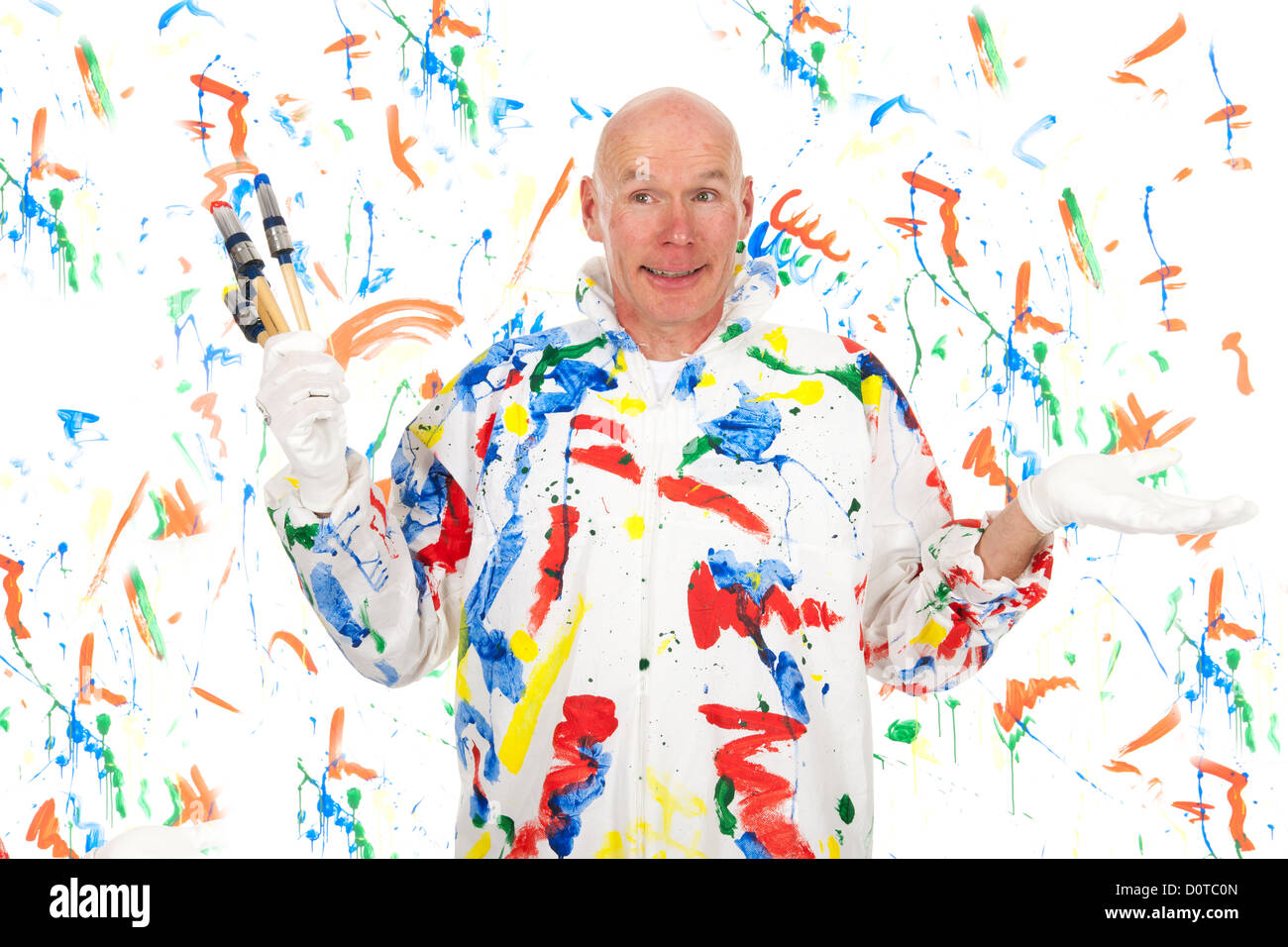 Painter with colorful paint brushes and safety mask is making a mess at ...