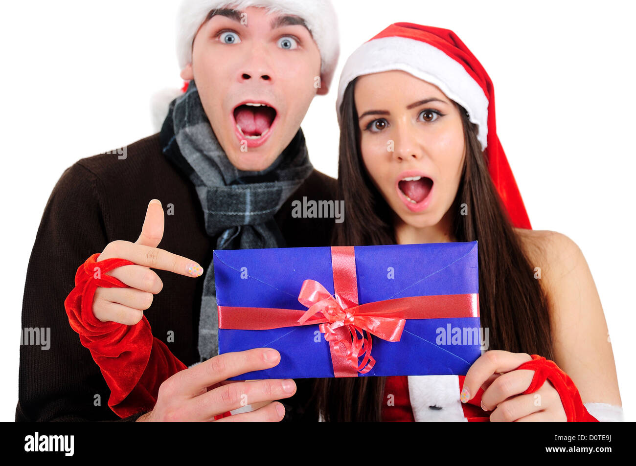Isolated Young Christmas Couple Shocked Stock Photo - Alamy