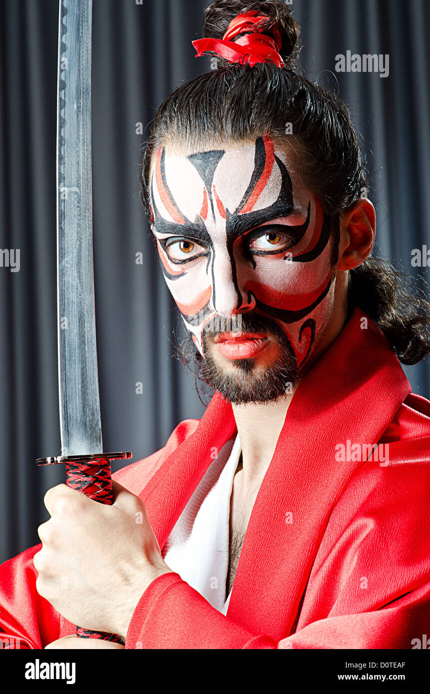 Man with face mask and sword Stock Photo - Alamy