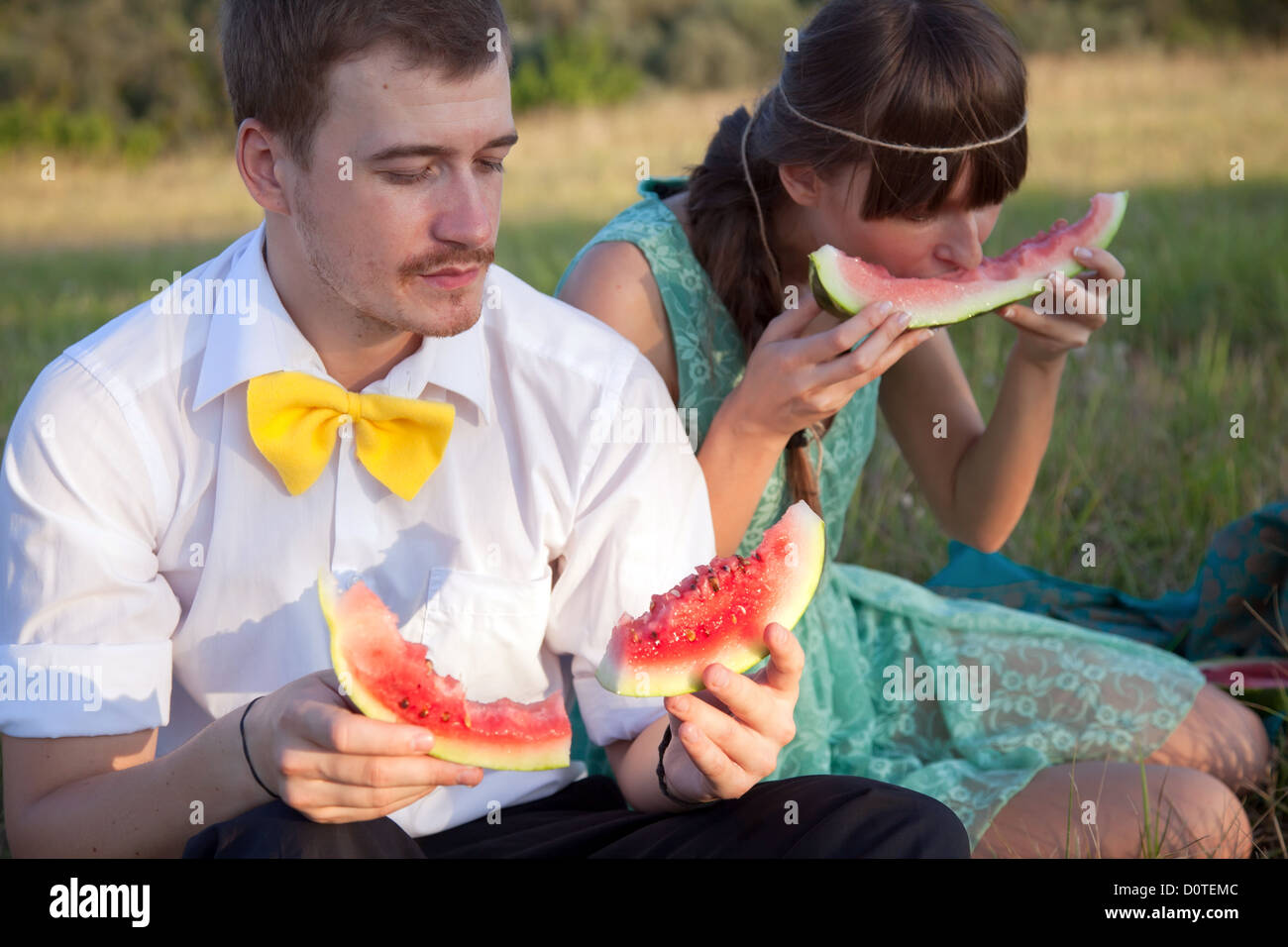 Young couple eating watermelon Stock Photo - Alamy