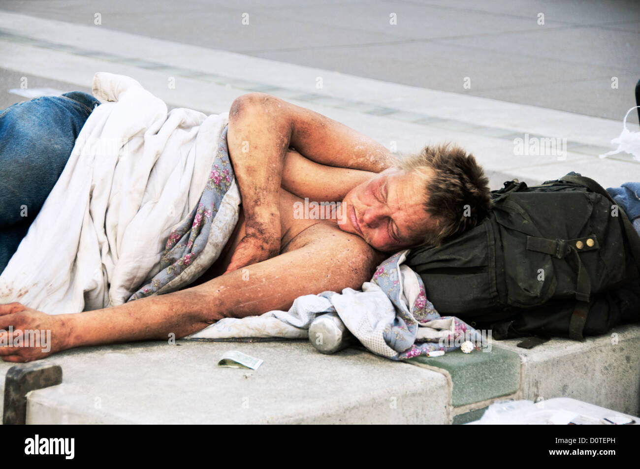 Homeless man sleeping on bench hi-res stock photography and images - Alamy
