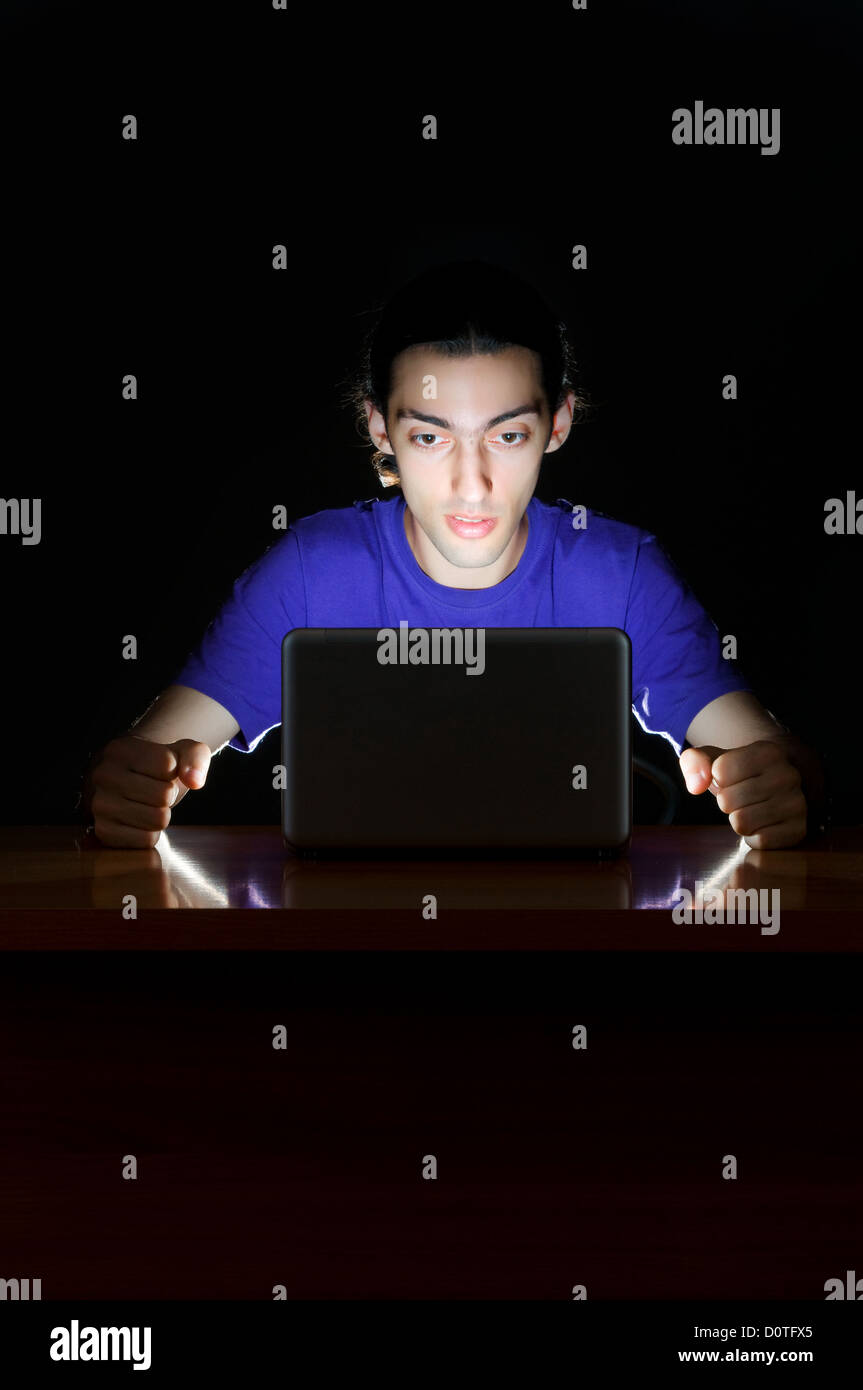 Hacker sitting in dark room Stock Photo - Alamy
