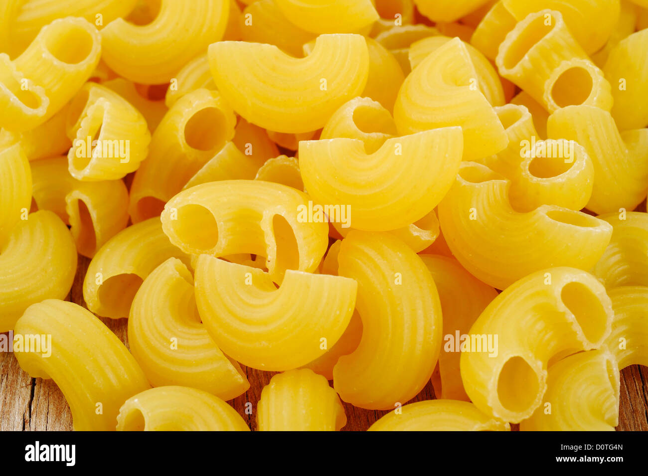 macaroni on wood background Stock Photo - Alamy