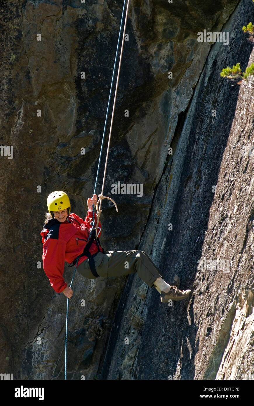Woman rappeling down a cliff in Patagonia, Chile Stock Photo - Alamy