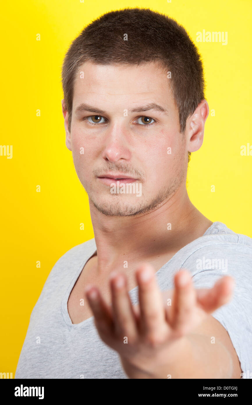 Kind young man giving out his hand Stock Photo - Alamy