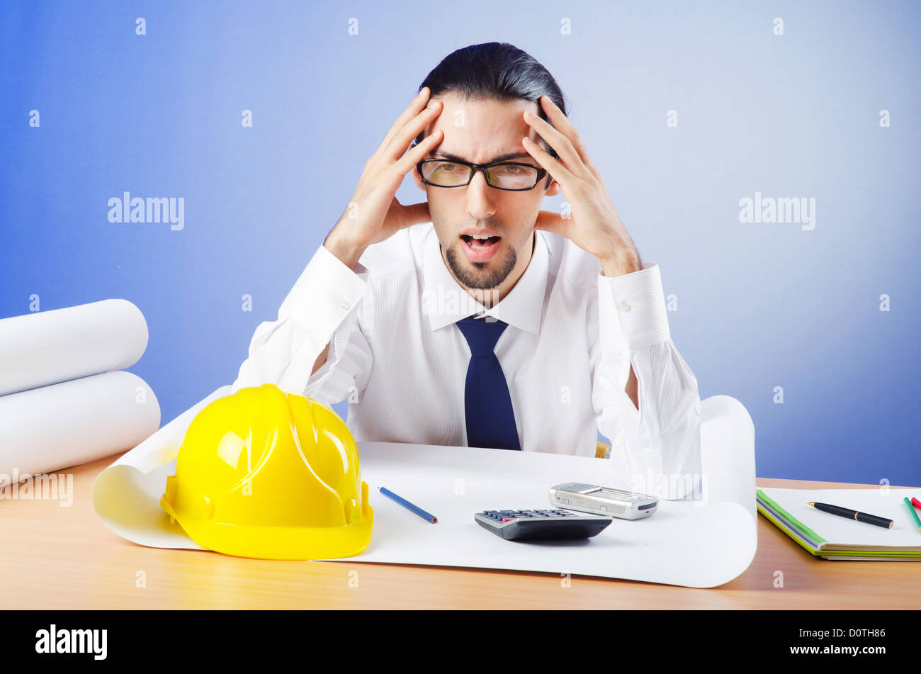 Young engineer looking at drawings Stock Photo - Alamy