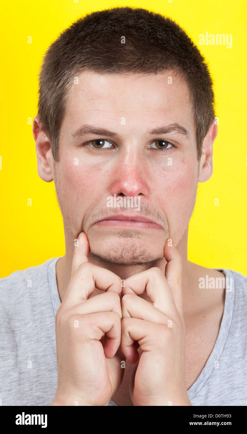 Sad man making unhappy face with hands Stock Photo - Alamy