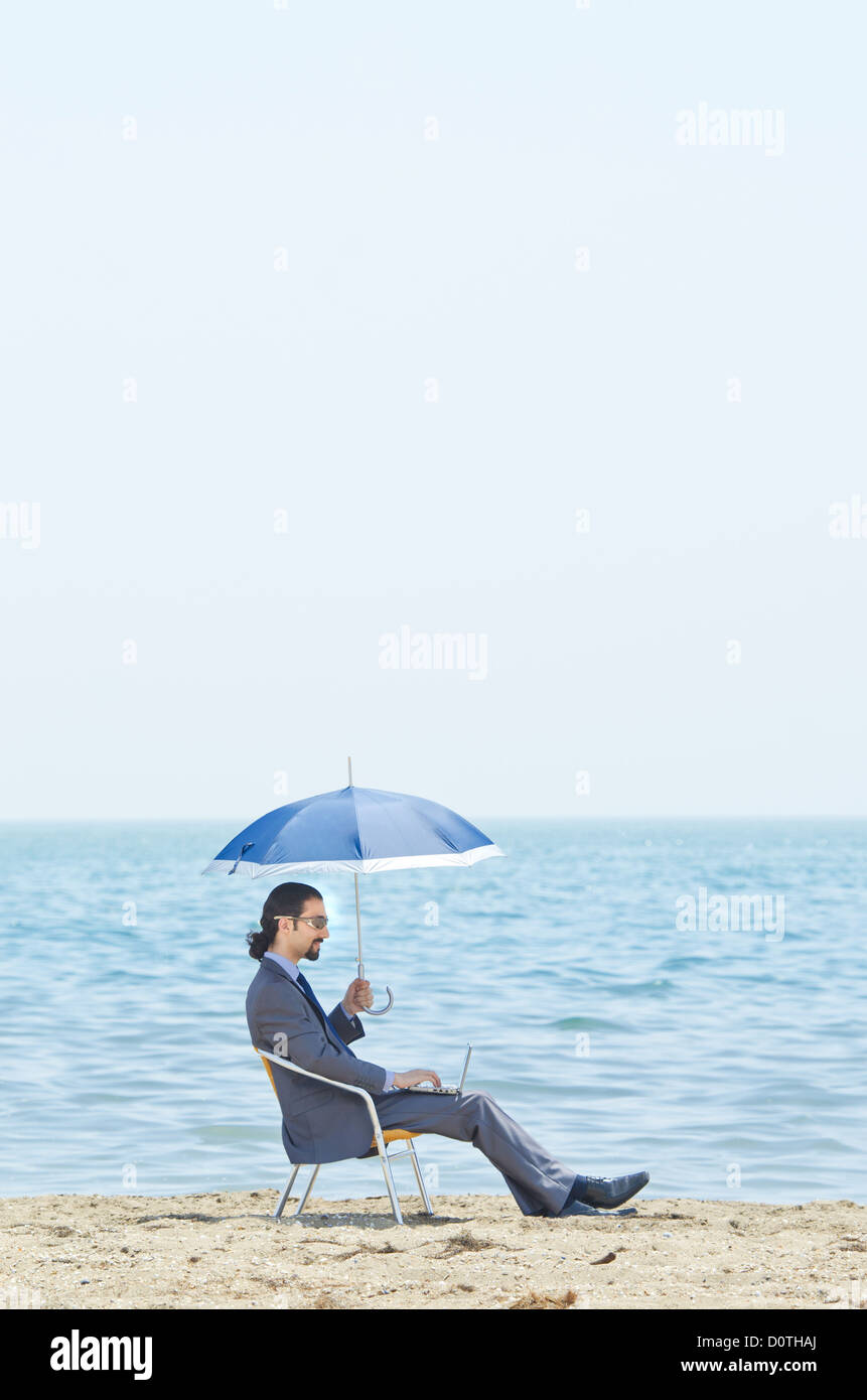 Man with umbrella on seaside beach Stock Photo - Alamy