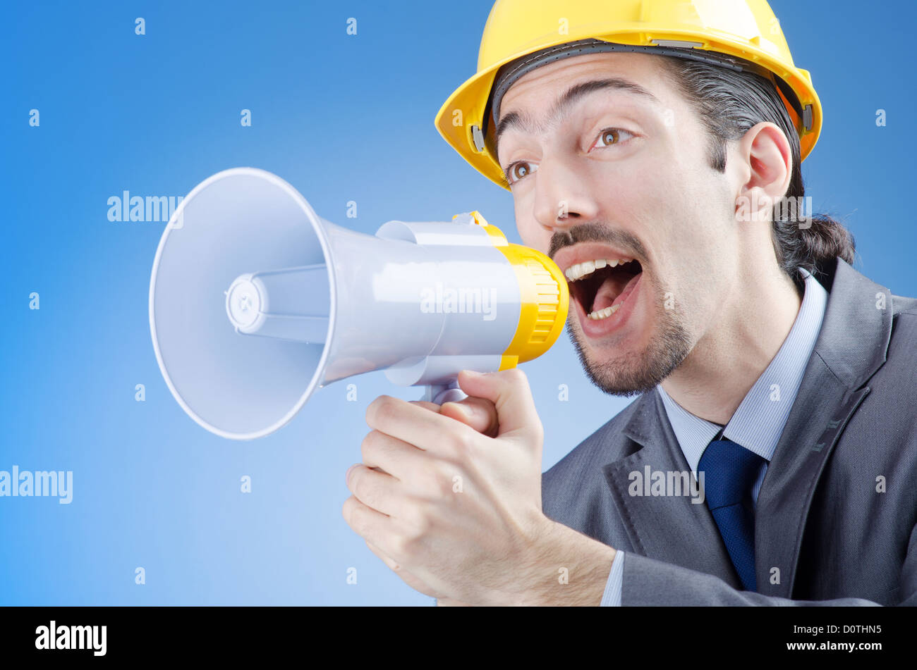 Construction worker shouting via loudspeaker Stock Photo - Alamy