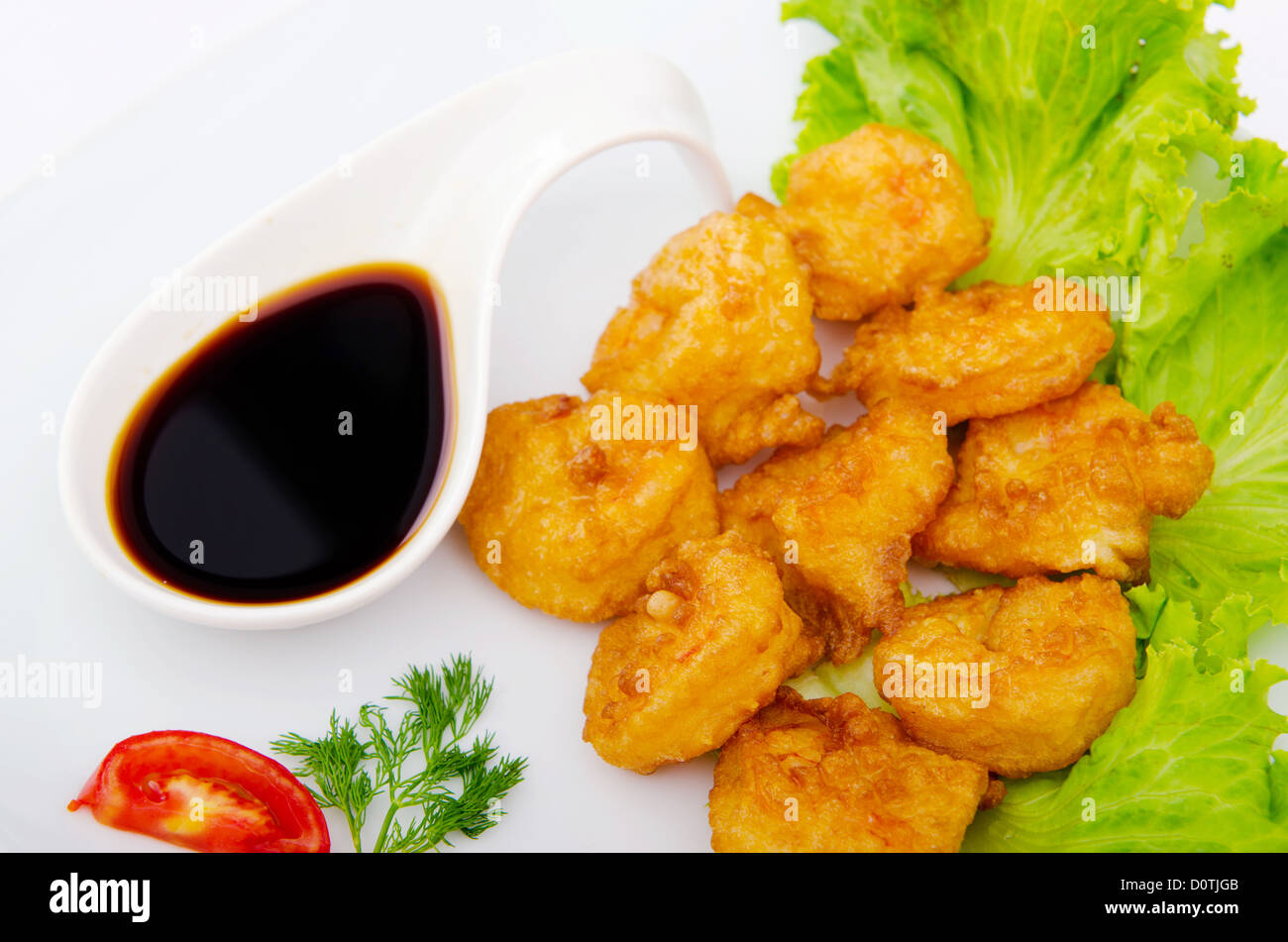 Breaded chicken pieces served with sauce Stock Photo - Alamy