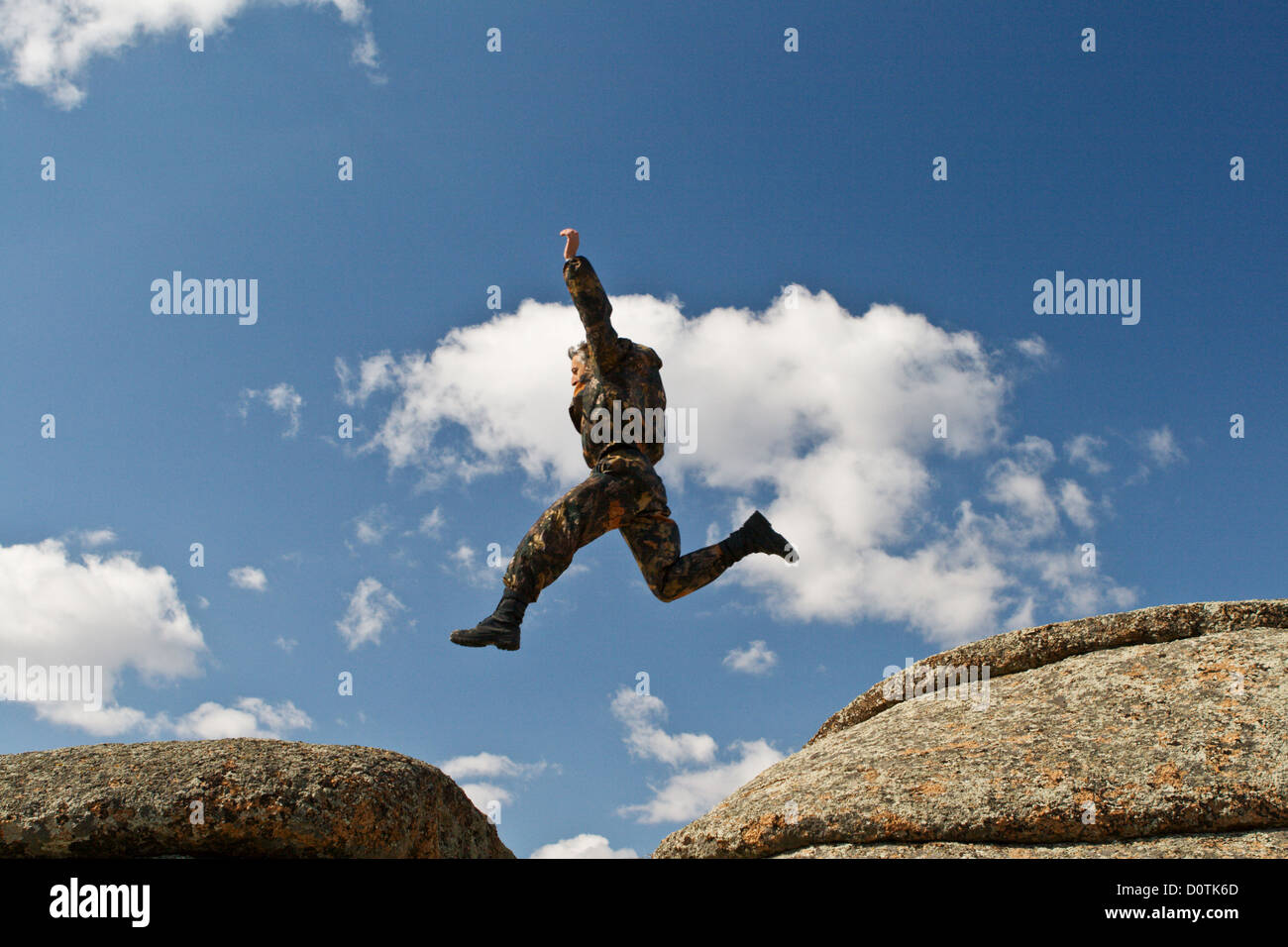 Man jump through the gap Stock Photo - Alamy
