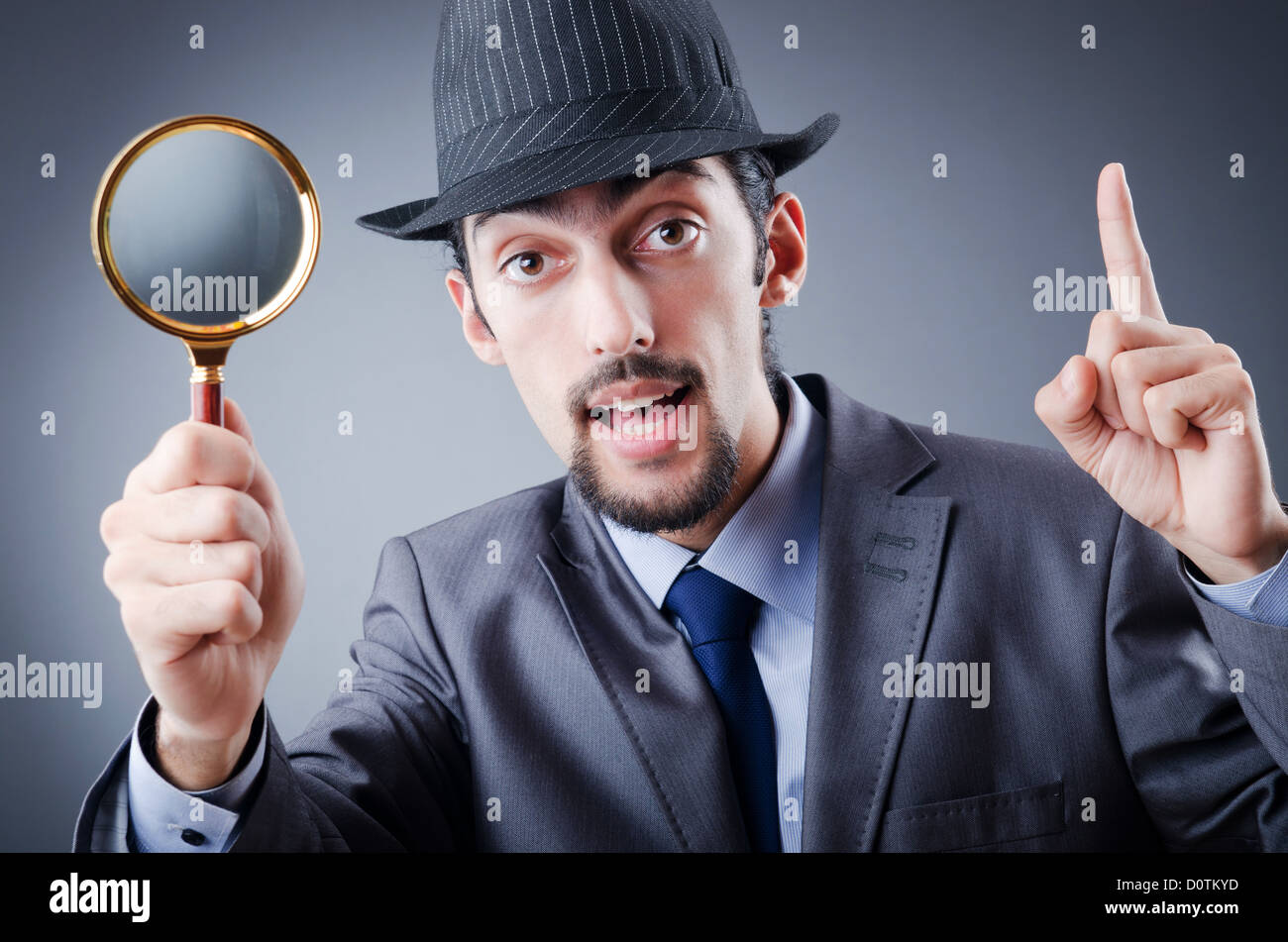 Detective and magnifying glass Stock Photo - Alamy
