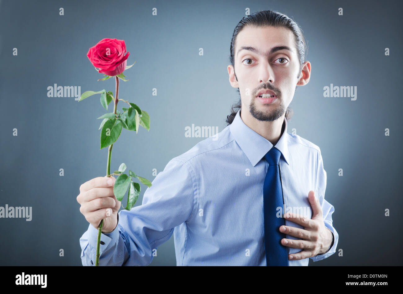 Young man with red rose Stock Photo - Alamy