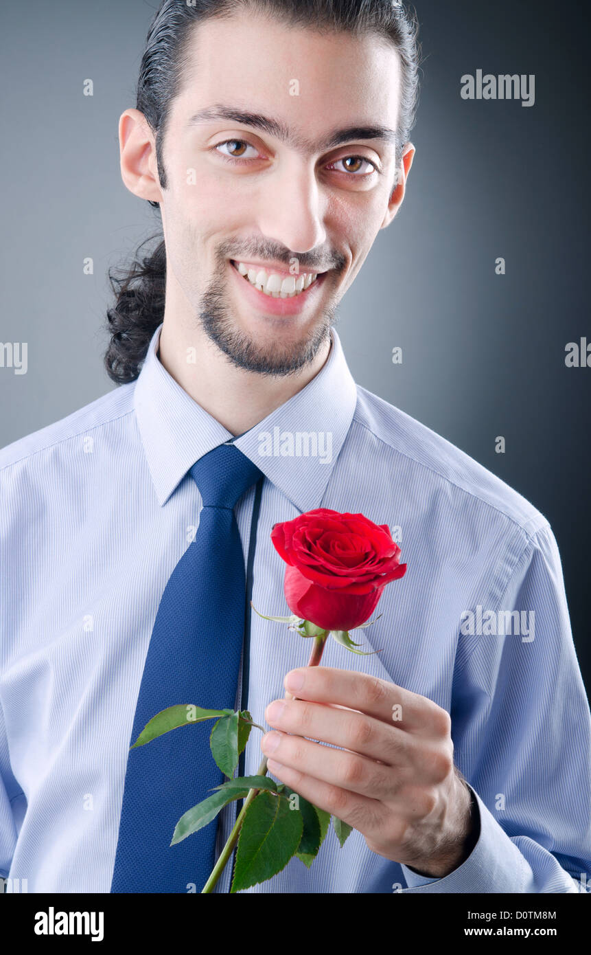 Young man with red rose Stock Photo - Alamy