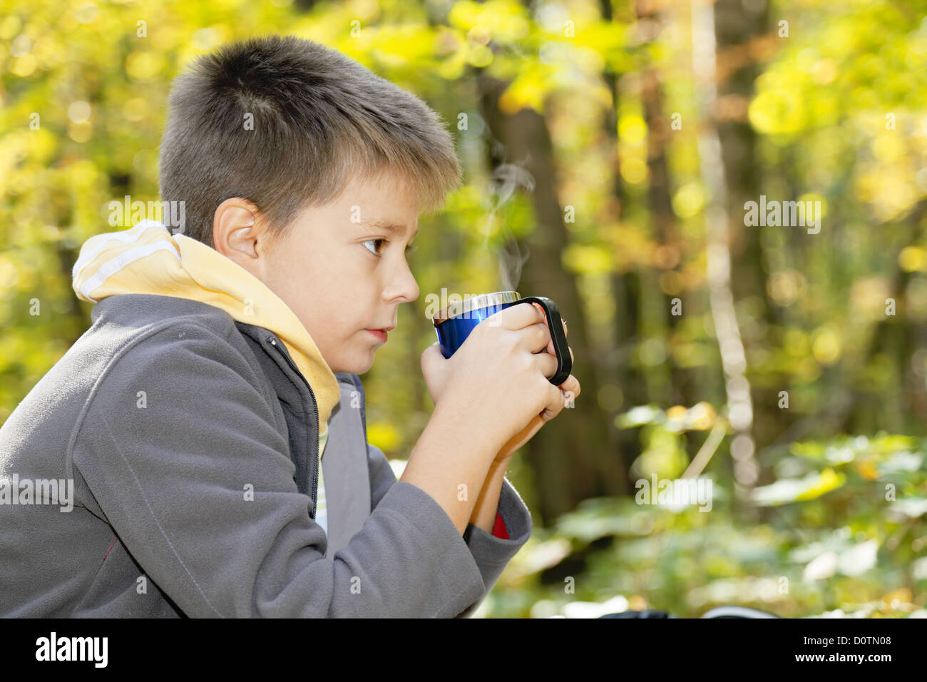 Boy holding cup of tea Stock Photo - Alamy