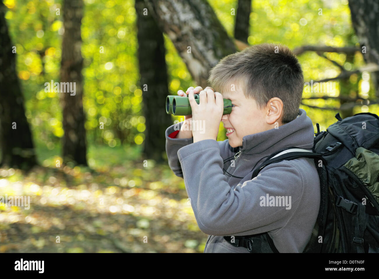 Boy looking through binoculars Stock Photo - Alamy