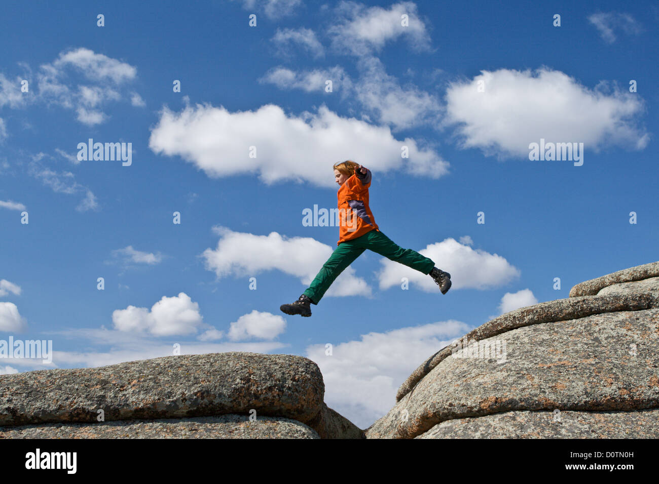 Women jump through the gap Stock Photo - Alamy