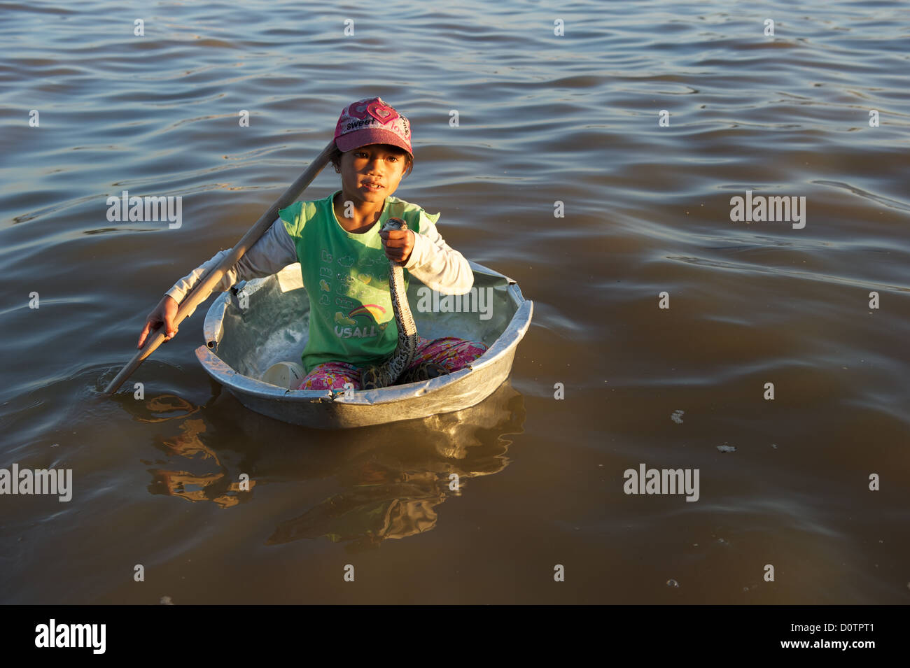 child floating in tub with snake Stock Photo - Alamy