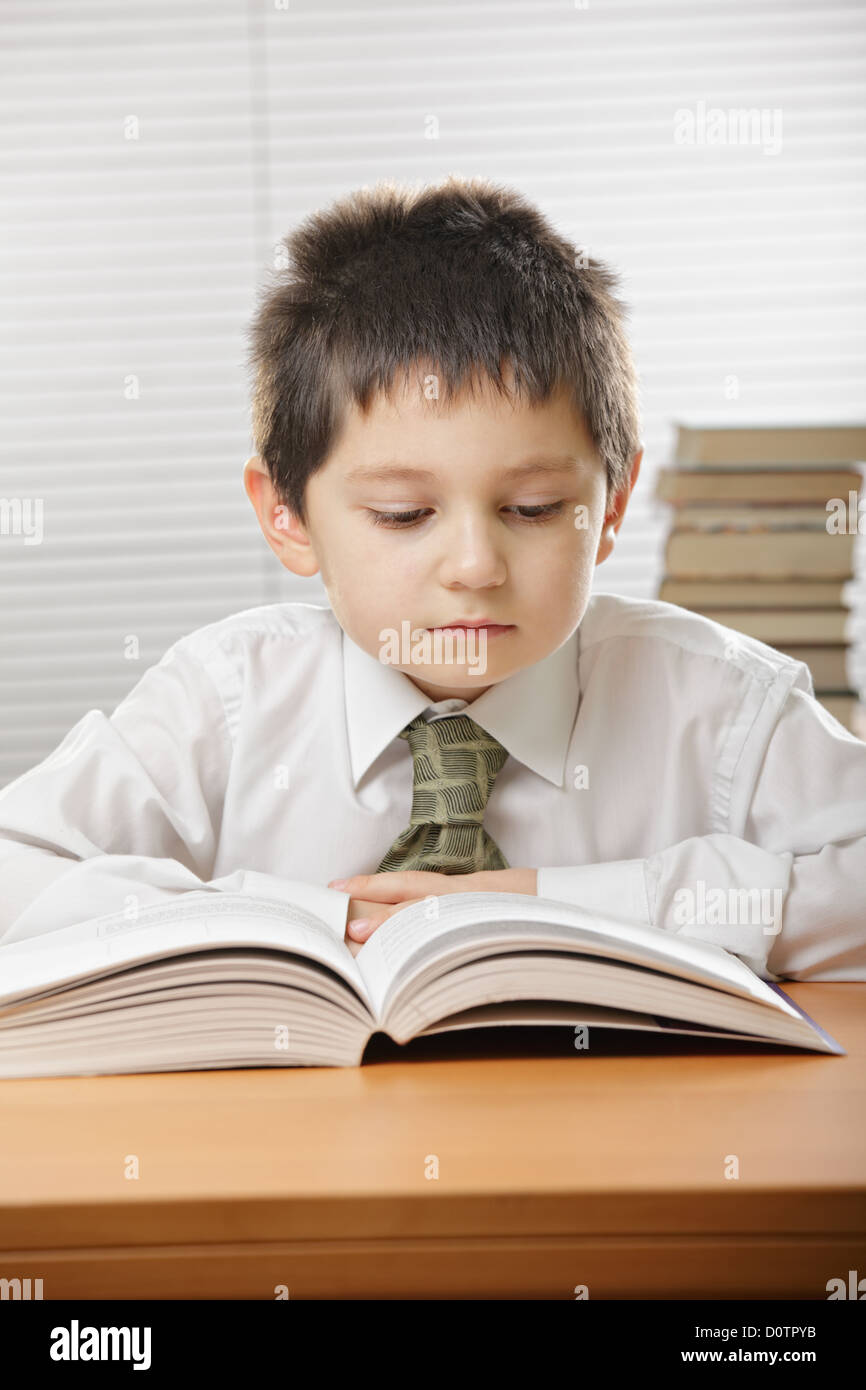 Boy reading book Stock Photo - Alamy