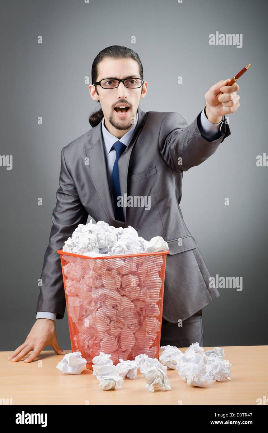 Man with lots of wasted paper Stock Photo - Alamy