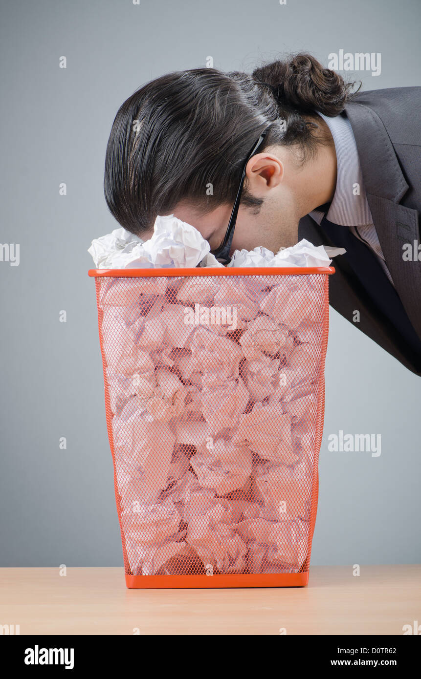Man with lots of wasted paper Stock Photo - Alamy