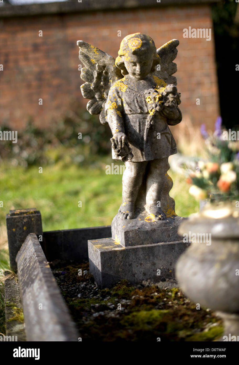 A stone angel stands over a grave Stock Photo - Alamy