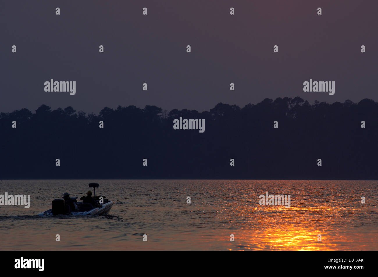 Fishermen in a bass boat at sunset on Lake Sam Rayburn Texas Stock ...