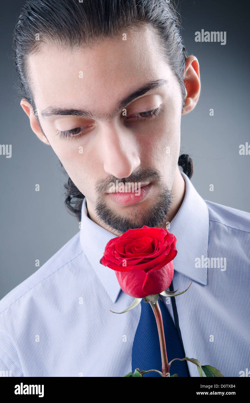 Young man with red rose Stock Photo - Alamy