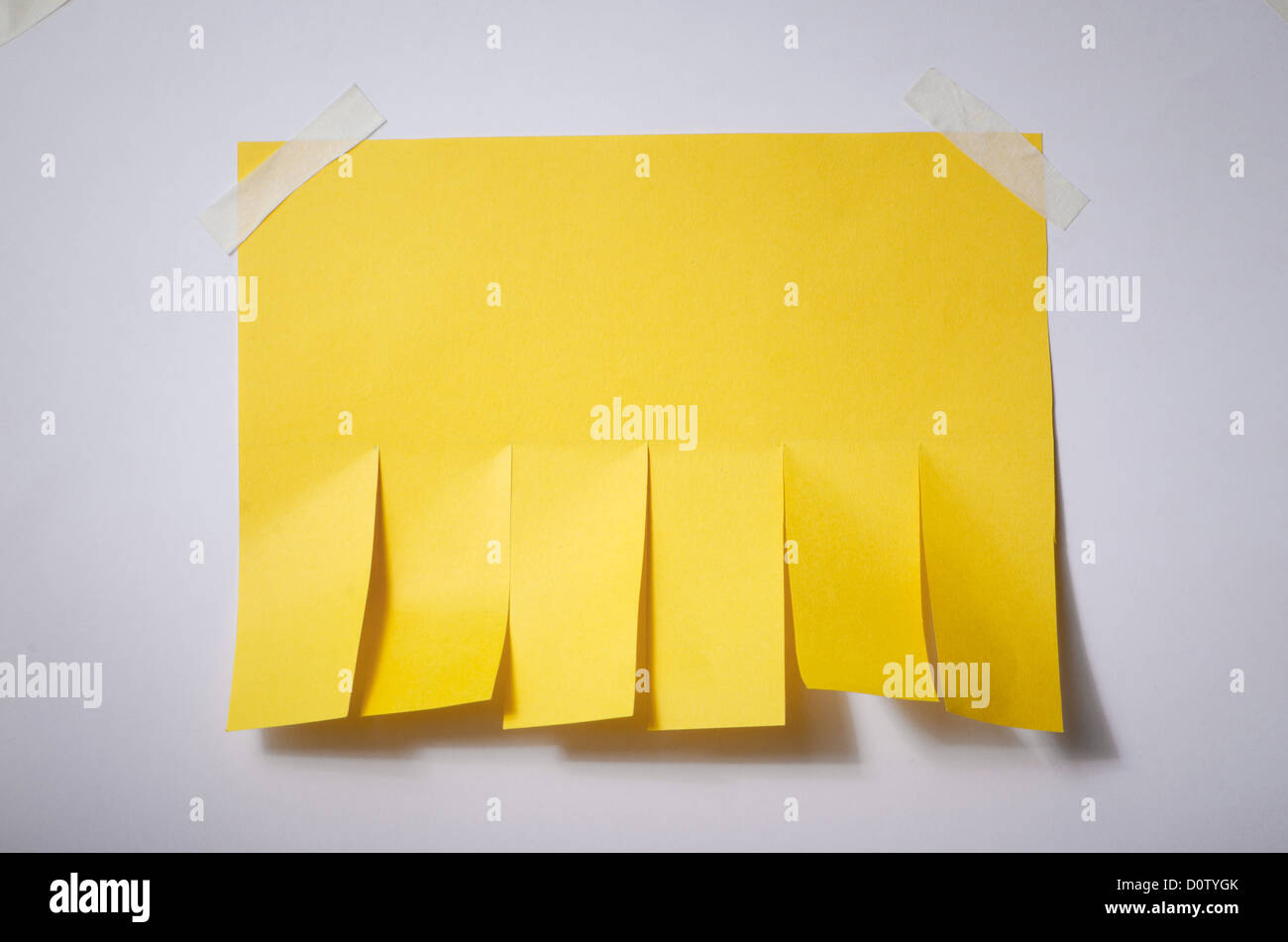 Tear off paper notice on the wall Stock Photo - Alamy