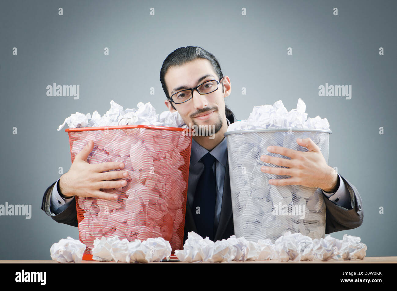Man with lots of wasted paper Stock Photo - Alamy