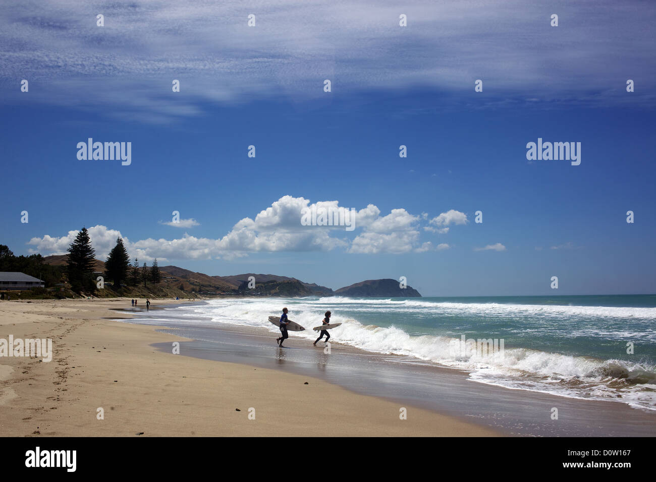 Surfers in action at Wainui Beach, near Gisborne. Wainui beach is world ...