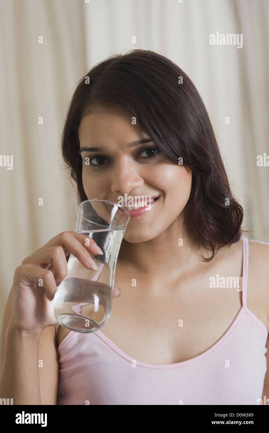 Portrait of a woman drinking water Stock Photo - Alamy