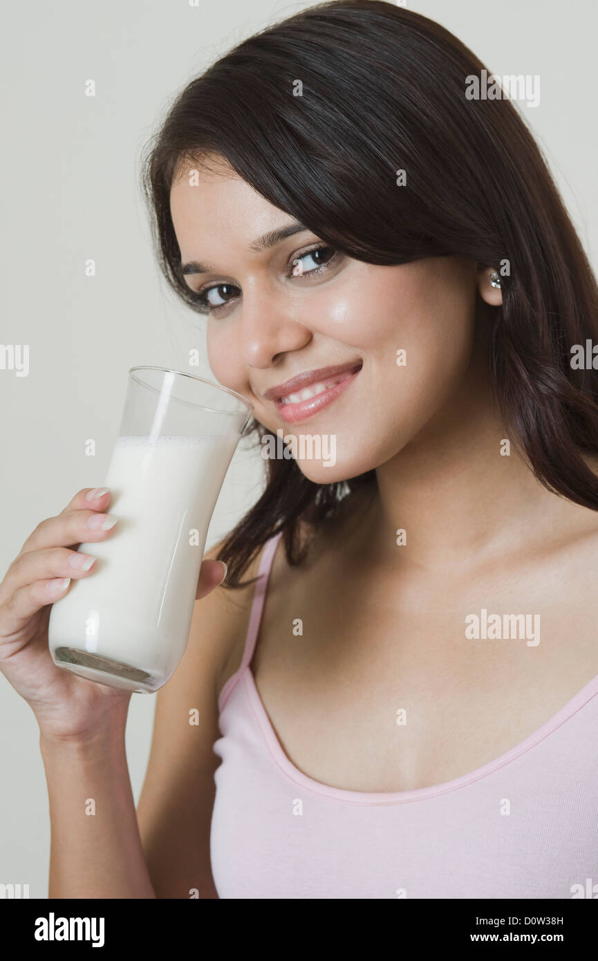 Portrait of a woman drinking milk Stock Photo - Alamy