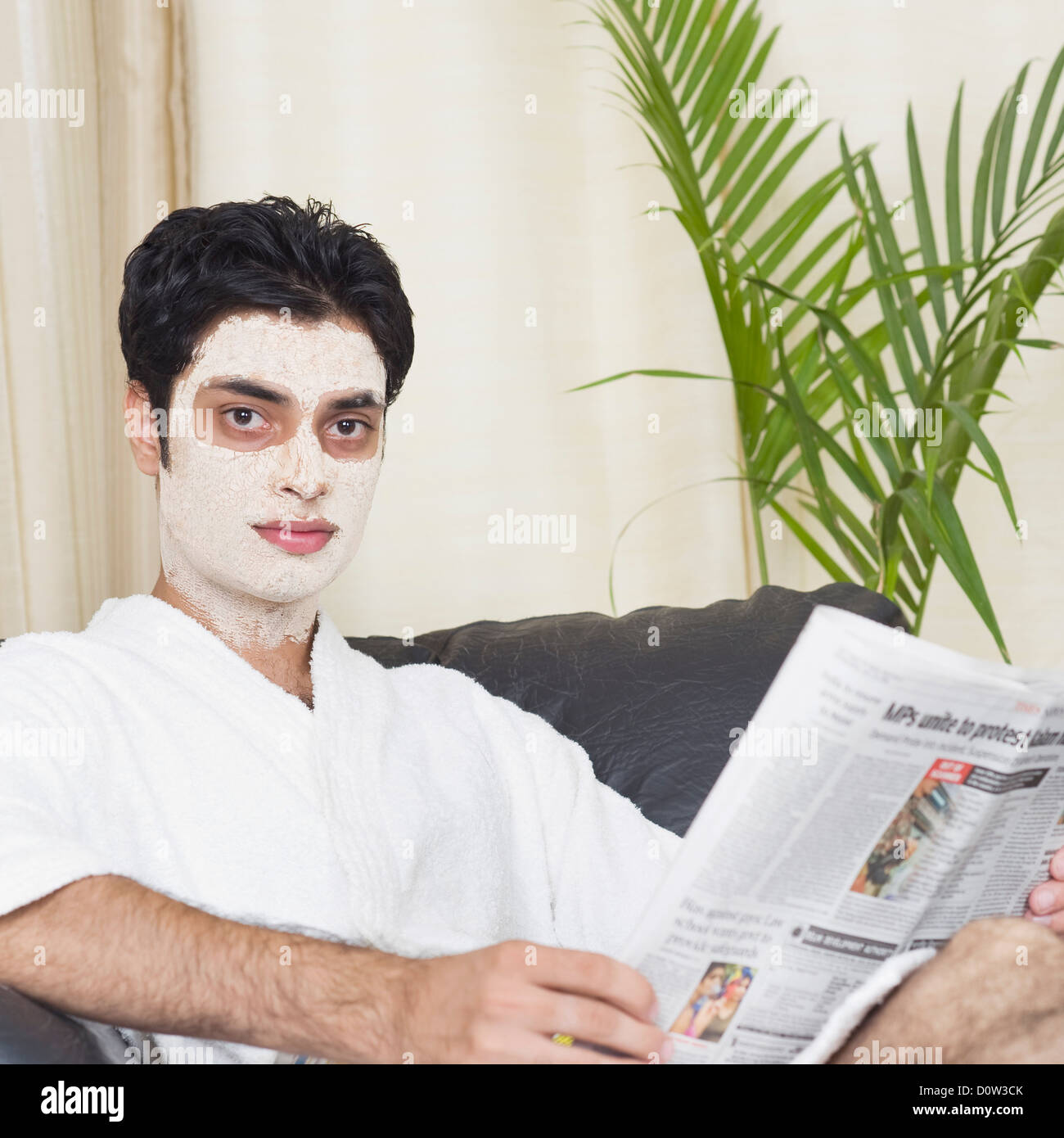 Man with facial mask reading a newspaper Stock Photo - Alamy