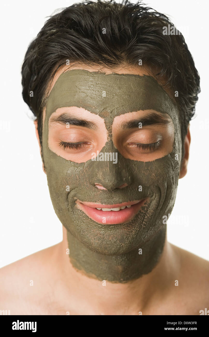 Close-up of a man with mud pack and day dreaming Stock Photo - Alamy