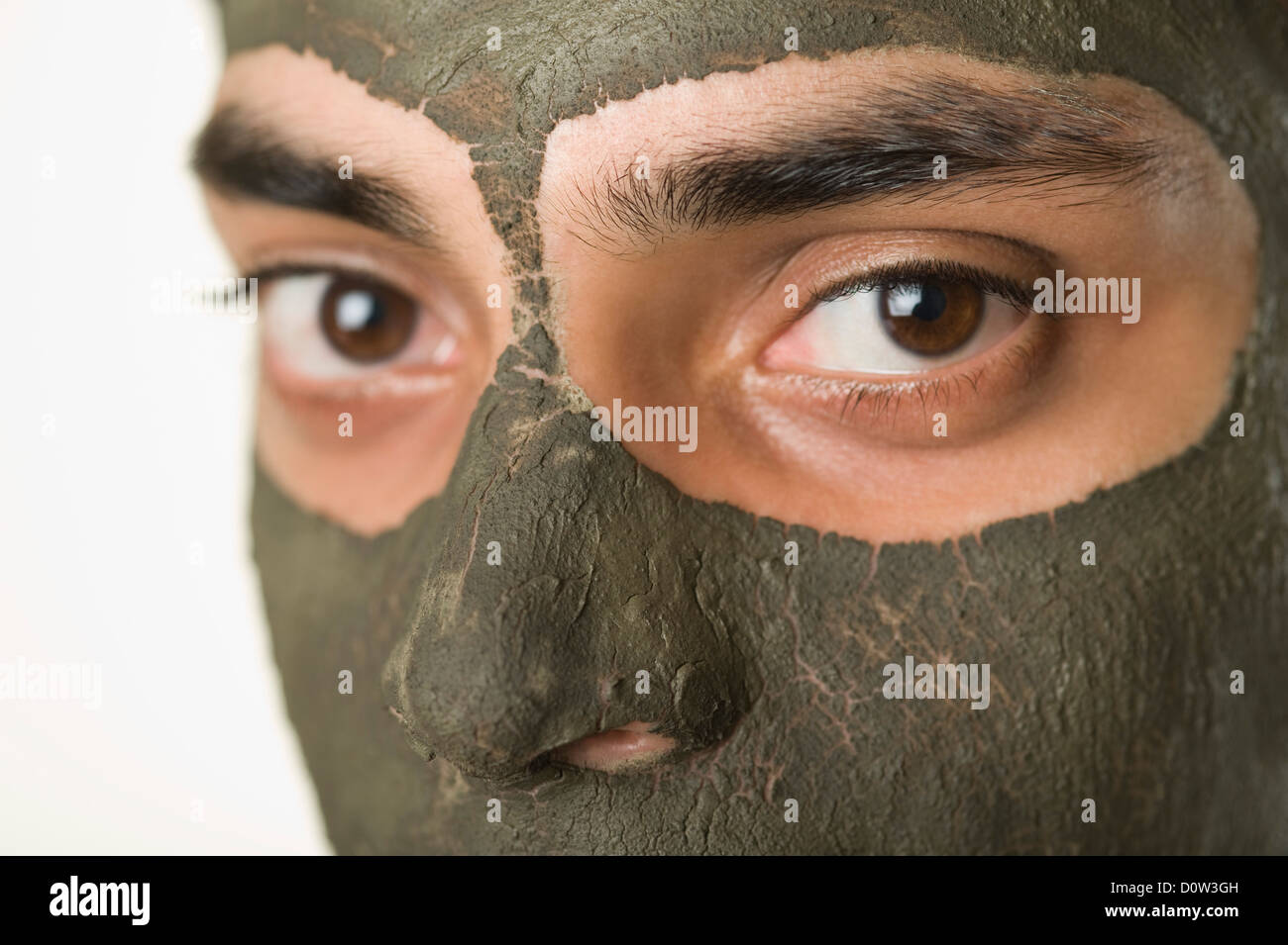 Portrait of a man with mud pack Stock Photo - Alamy