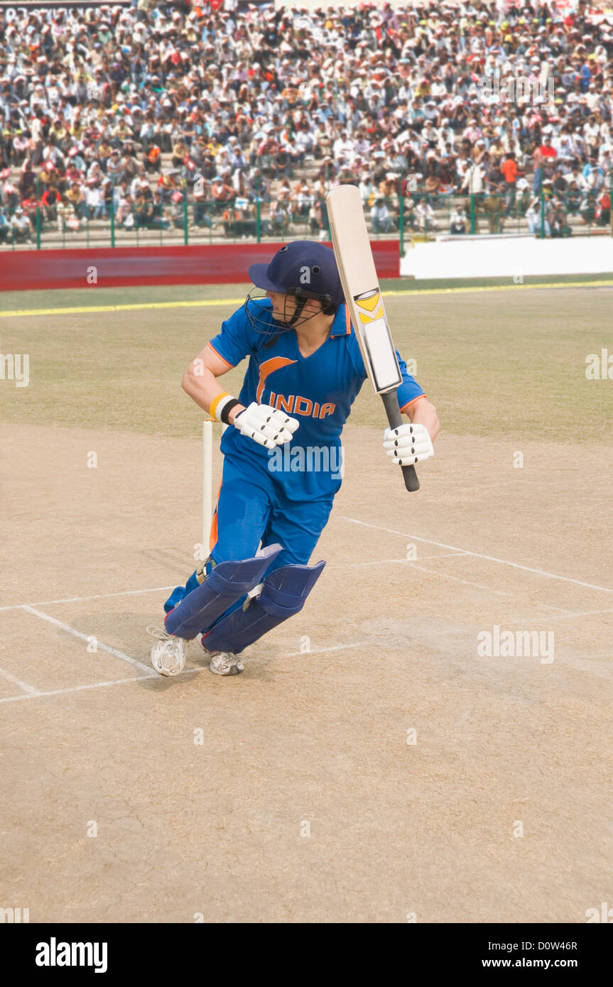 Cricket batsman in running position after playing a shot Stock Photo ...