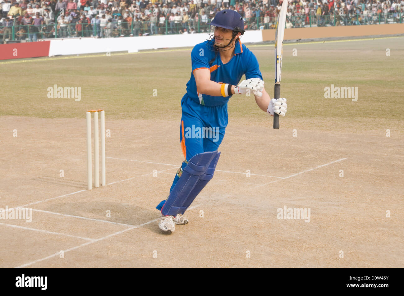 Cricket batsman in running position after playing a shot Stock Photo ...