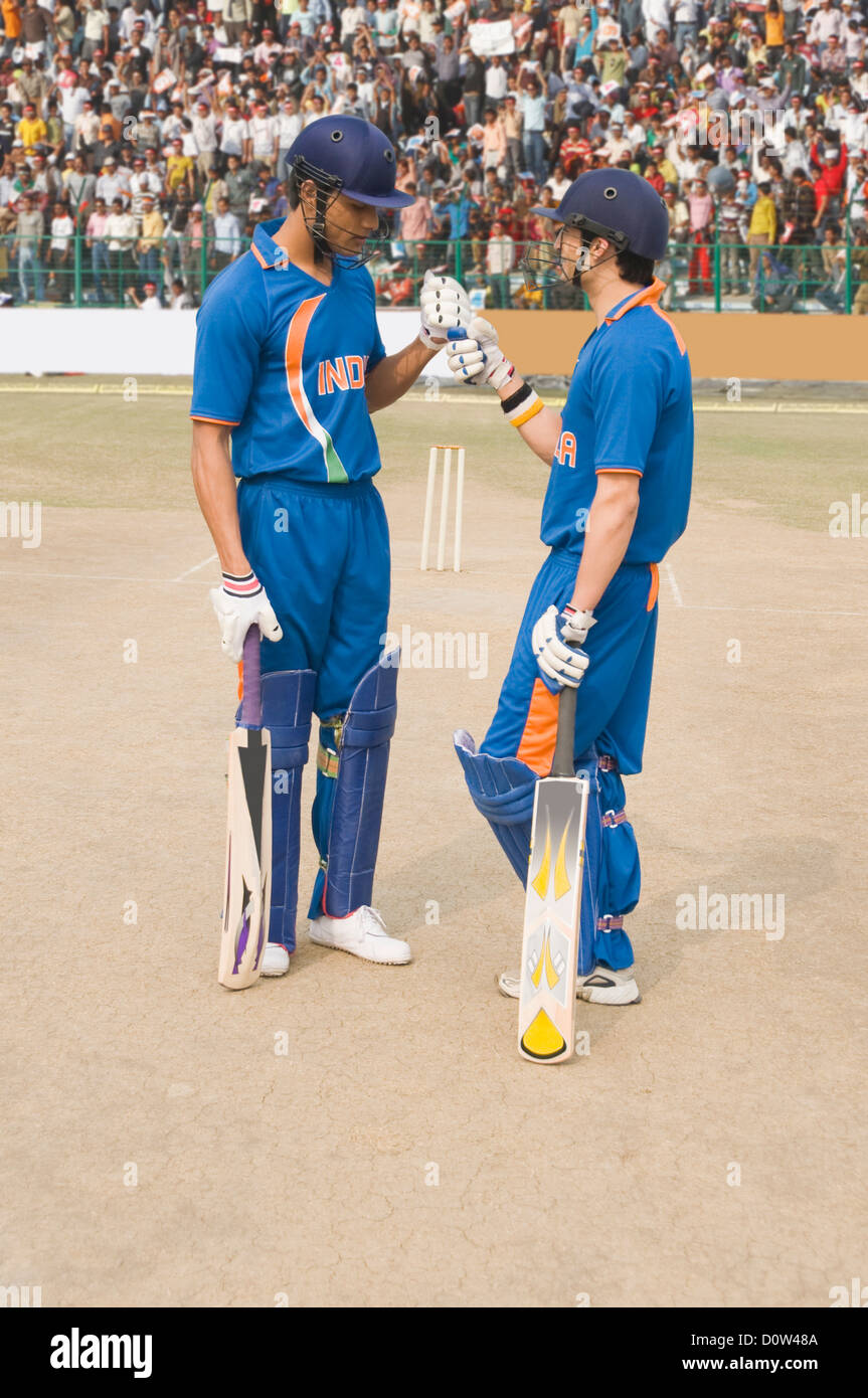 Two cricket batsmen discussing at wicket Stock Photo - Alamy