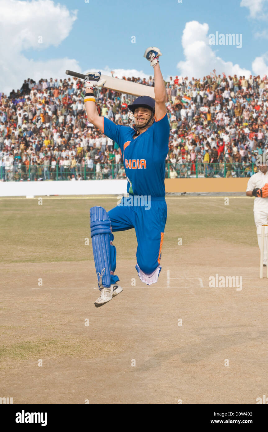 Cricket batsman jumping in excitement Stock Photo - Alamy