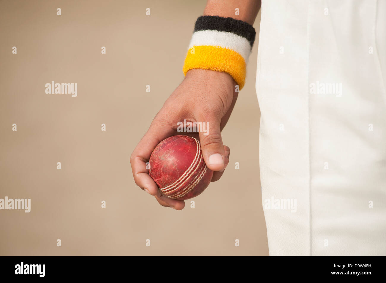 Cricket bowler holding a ball Stock Photo - Alamy